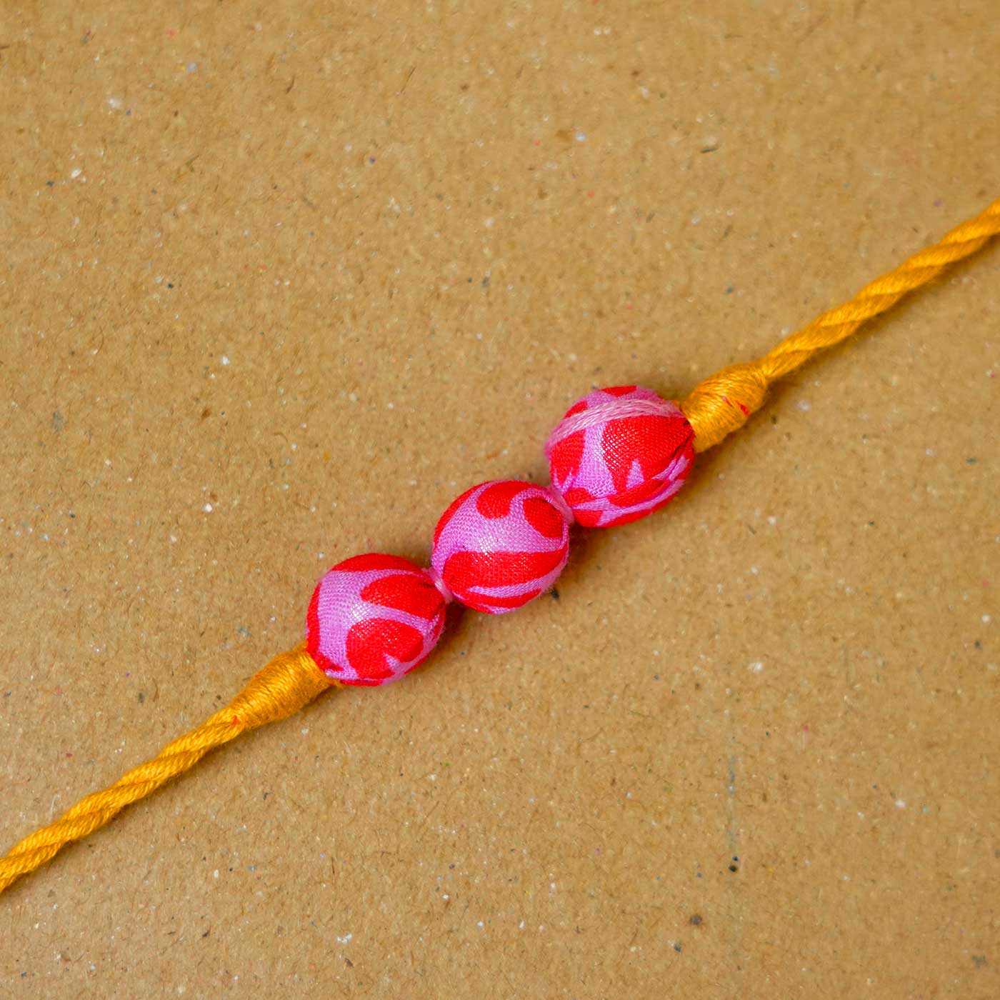 Buy Handmade Ochre Upcycled Fabric Rakhi With Roli Chawal Online On Zwende