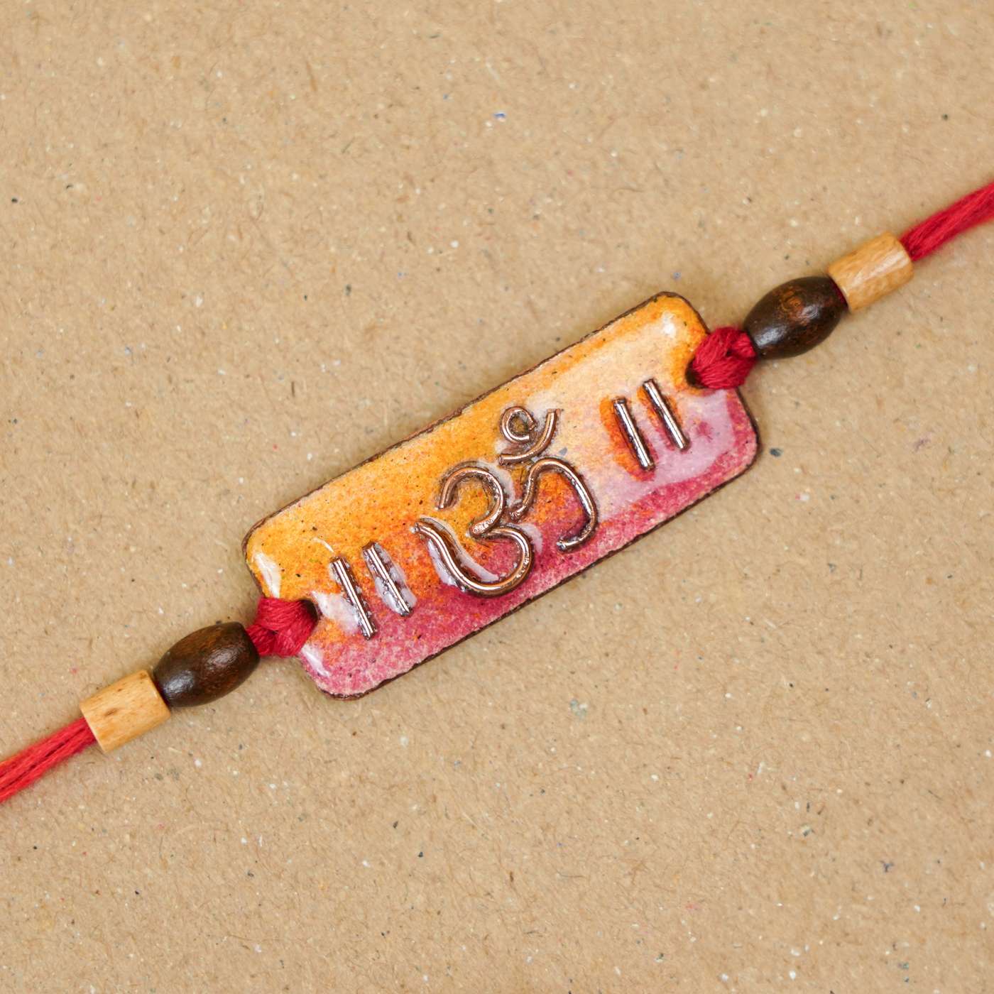 Buy Handmade Rectangle Om Copper Enamel Rakhi With Chocolates & Roli ...