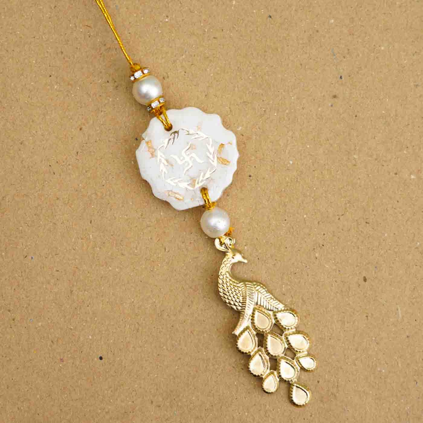 Buy Handmade White Resin Swastik Lumba Rakhi for Bhabhi With Roli ...