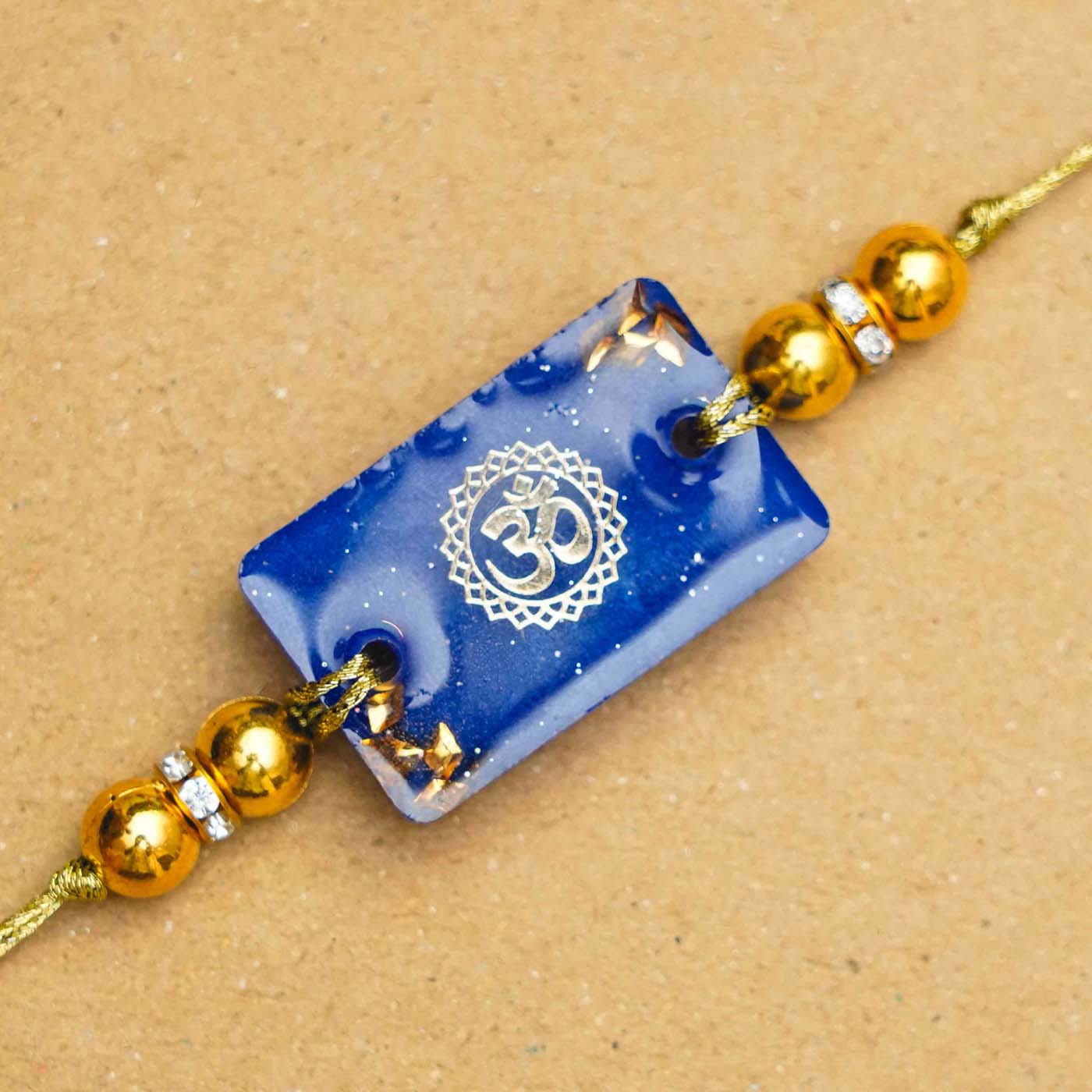 Buy Handmade Resin Rectangle Blue Om Rakhi With Roli Chawal Online On ...
