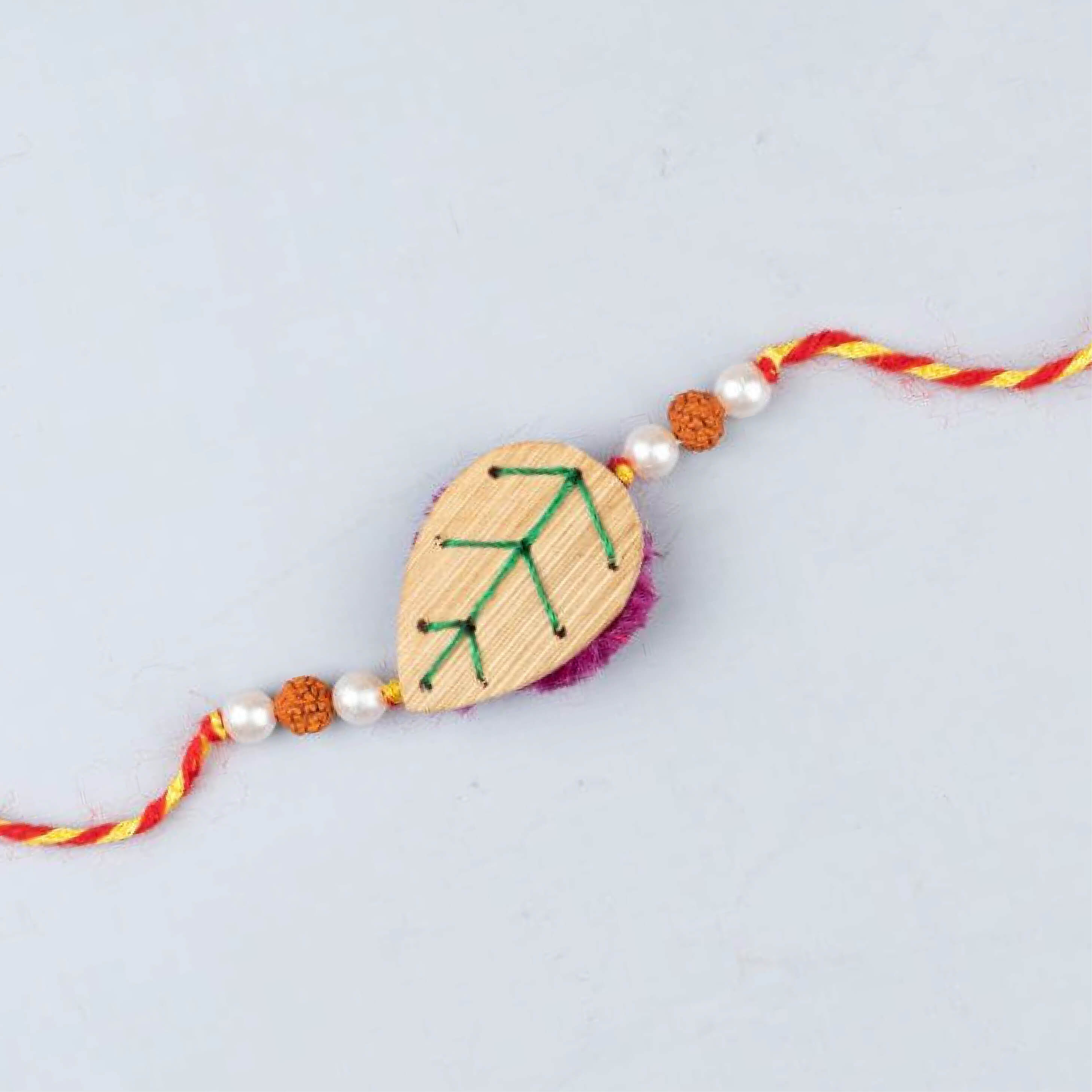 Buy Handcrafted Bamboo Leaf-shaped Rakhi With Roli Chawal Online On Zwende