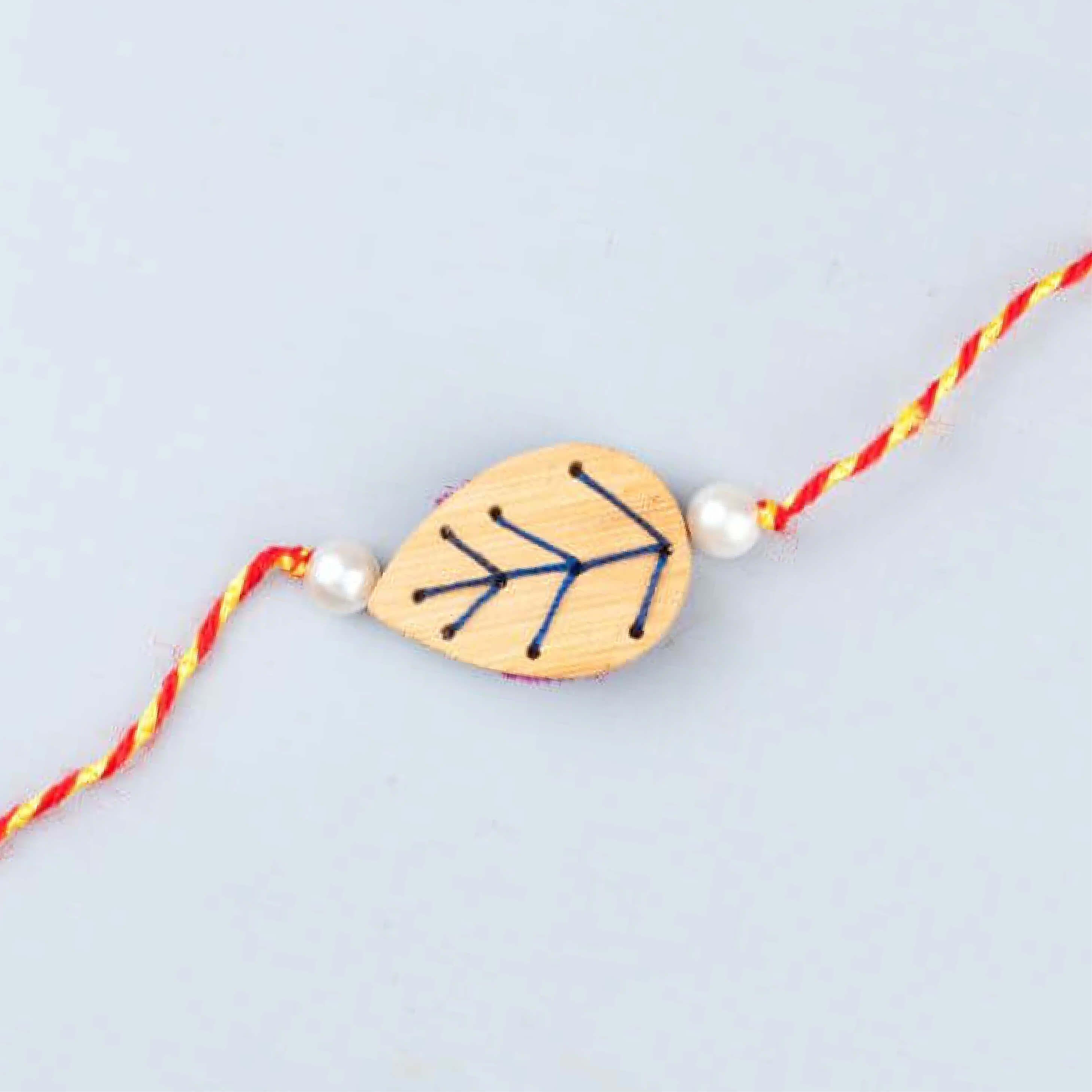 Buy Handcrafted Bamboo Leaf-shaped Rakhi With Roli Chawal Online On Zwende